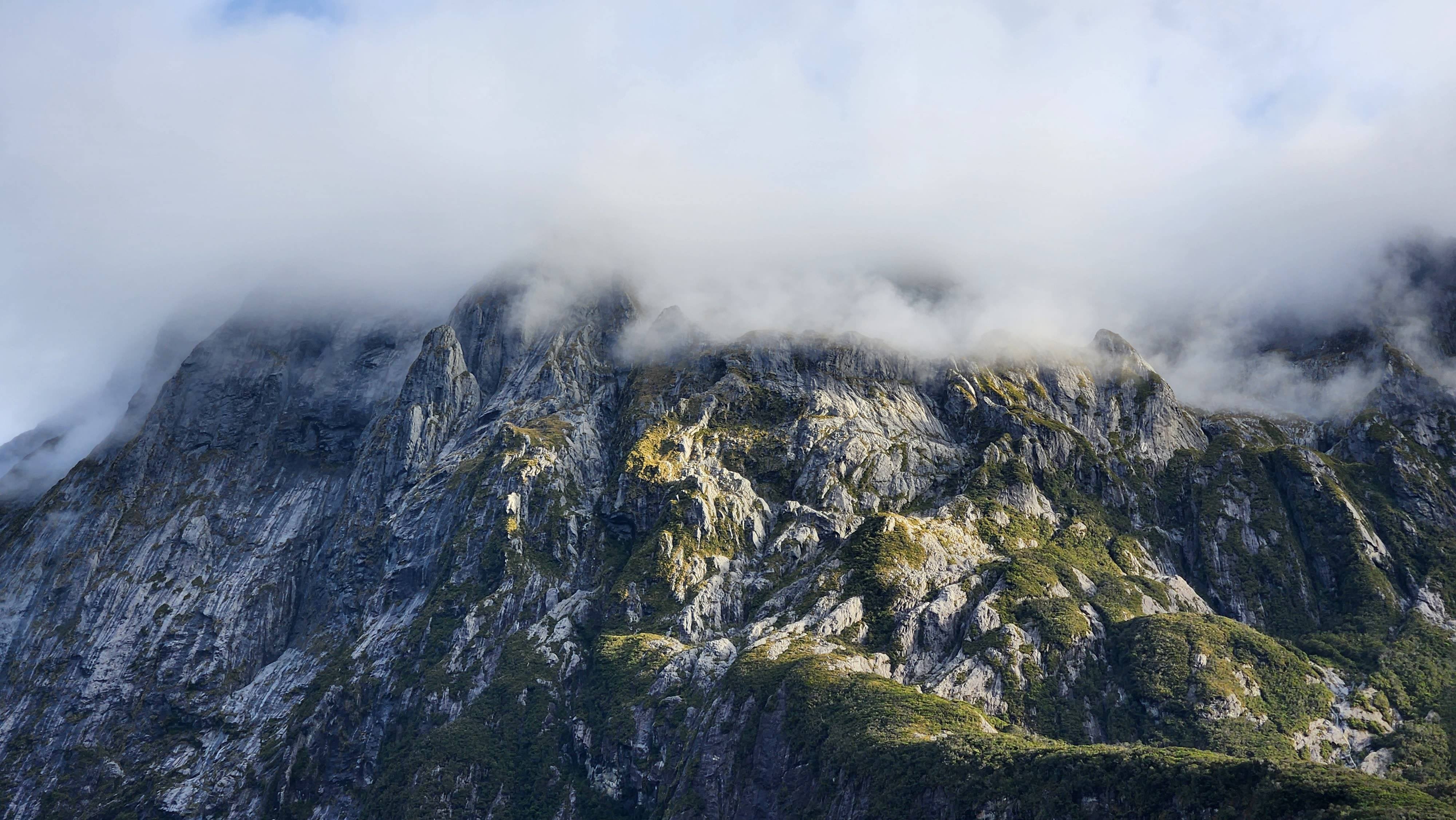 Evening sun on Mitre Peak, the world's tallest sea cliff. Milford Sound ...