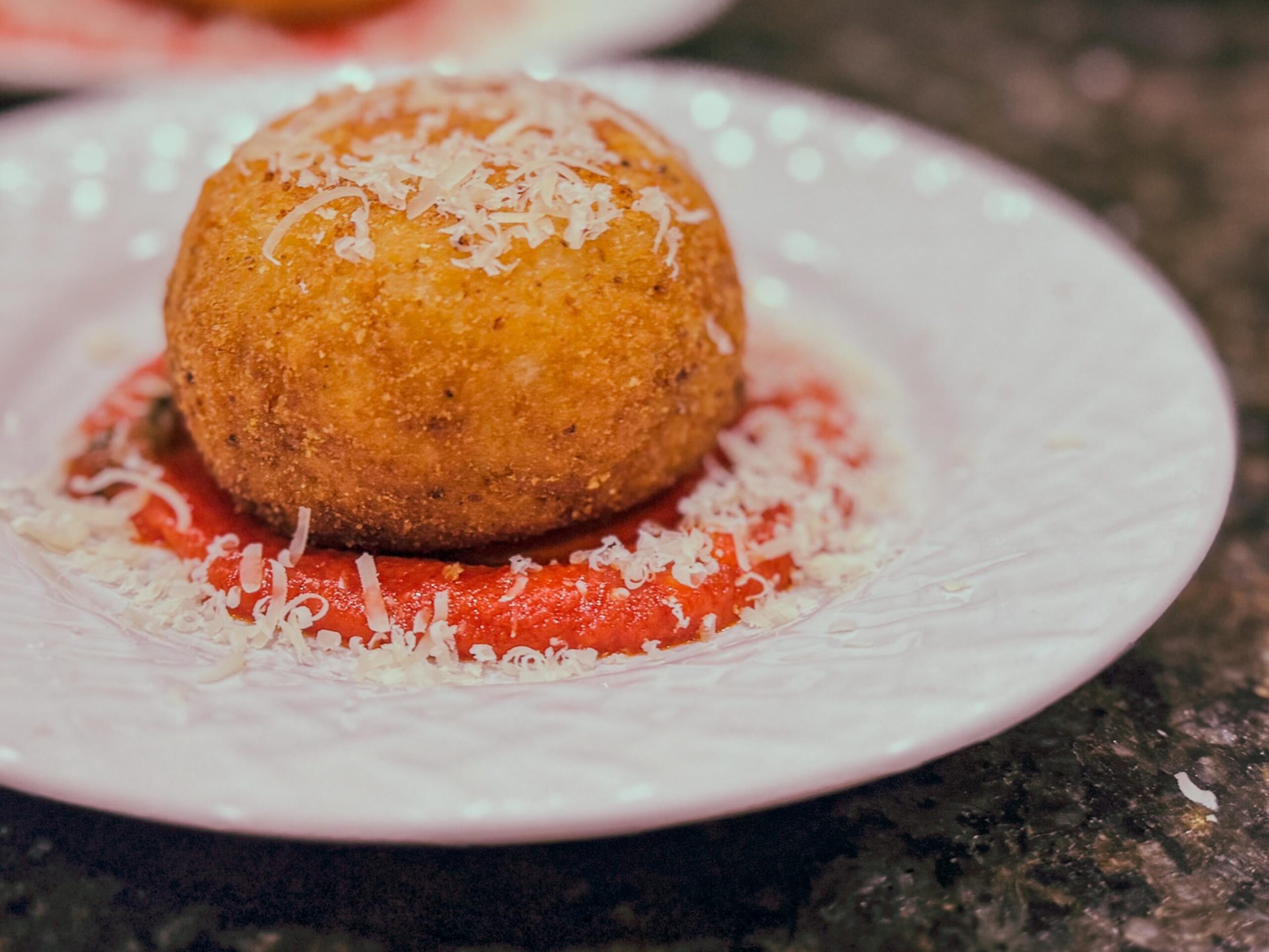 Arancini with garlic-herb risotto, homemade tomato sauce - La Vie Zine